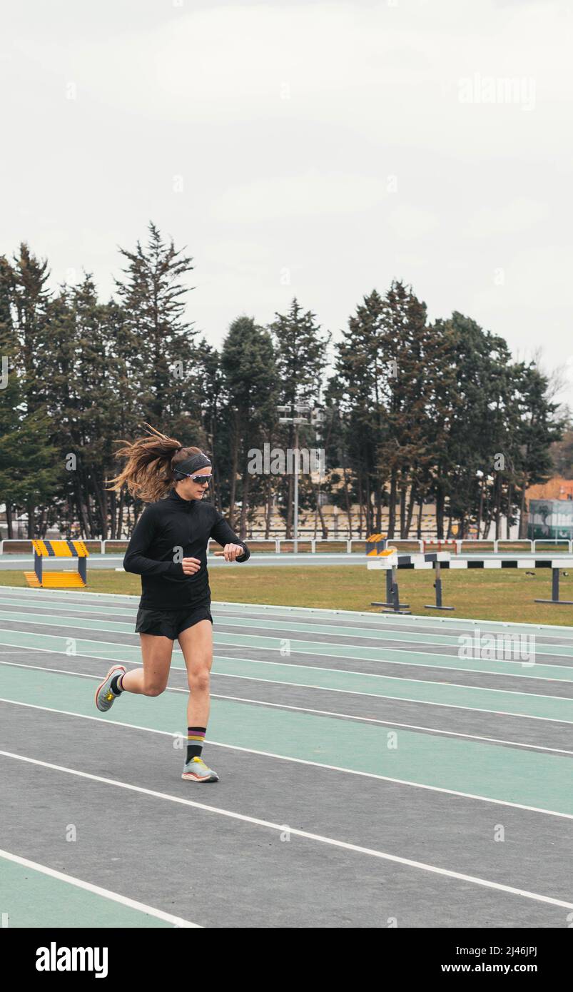 woman running on a running track Stock Photo - Alamy