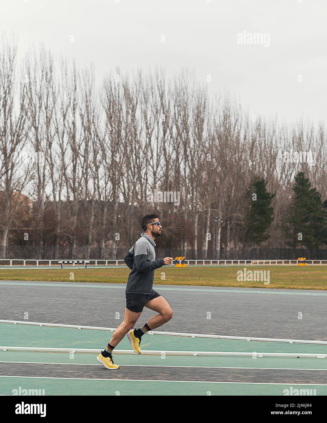 man running on a running track Stock Photo - Alamy