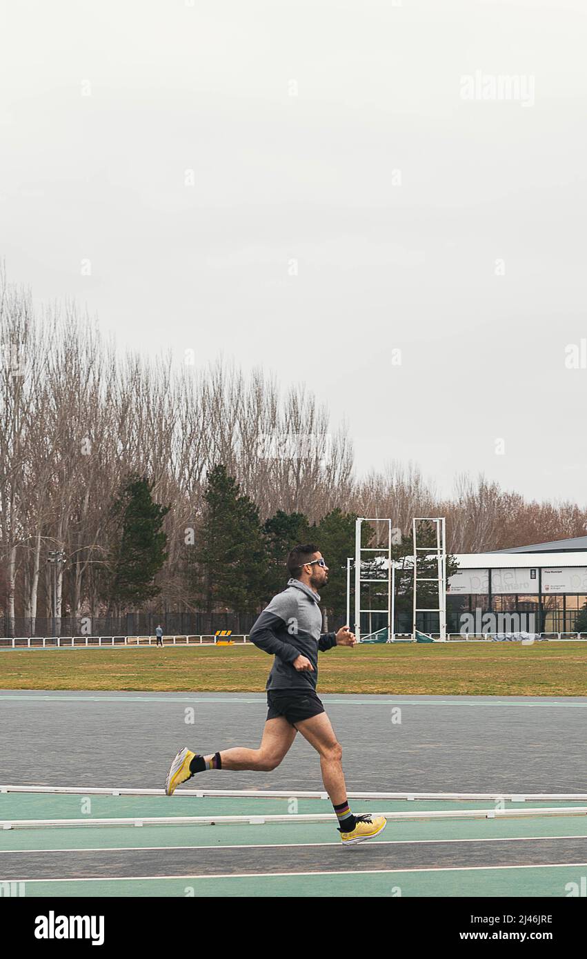 man running on a running track Stock Photo - Alamy
