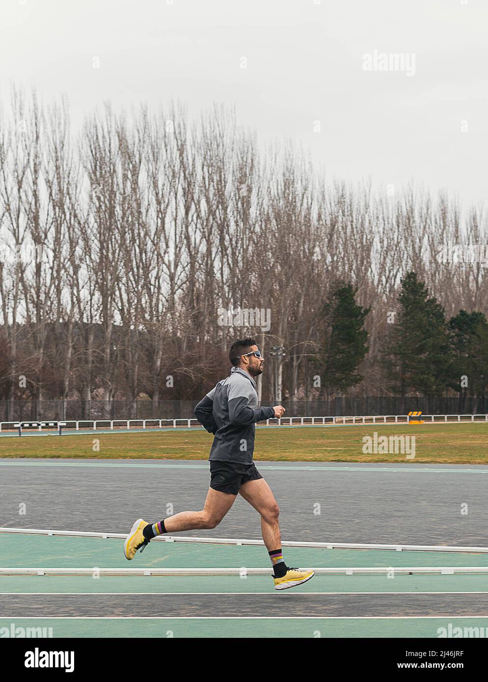 man running on a running track Stock Photo - Alamy