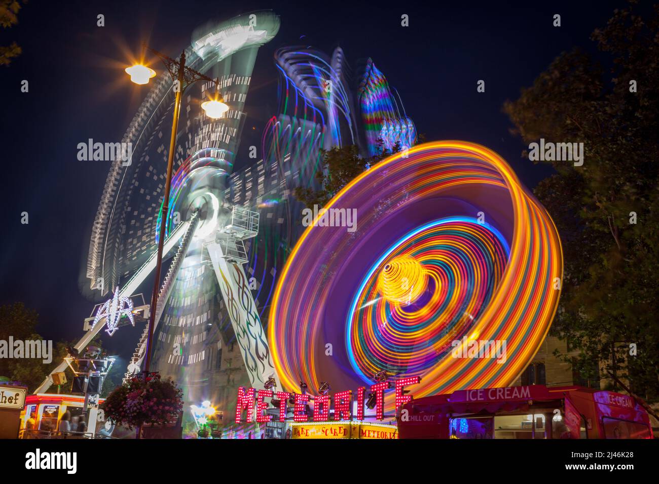 Long exposure image of the The 'Air' and 'Metorite' fairground rides at ...