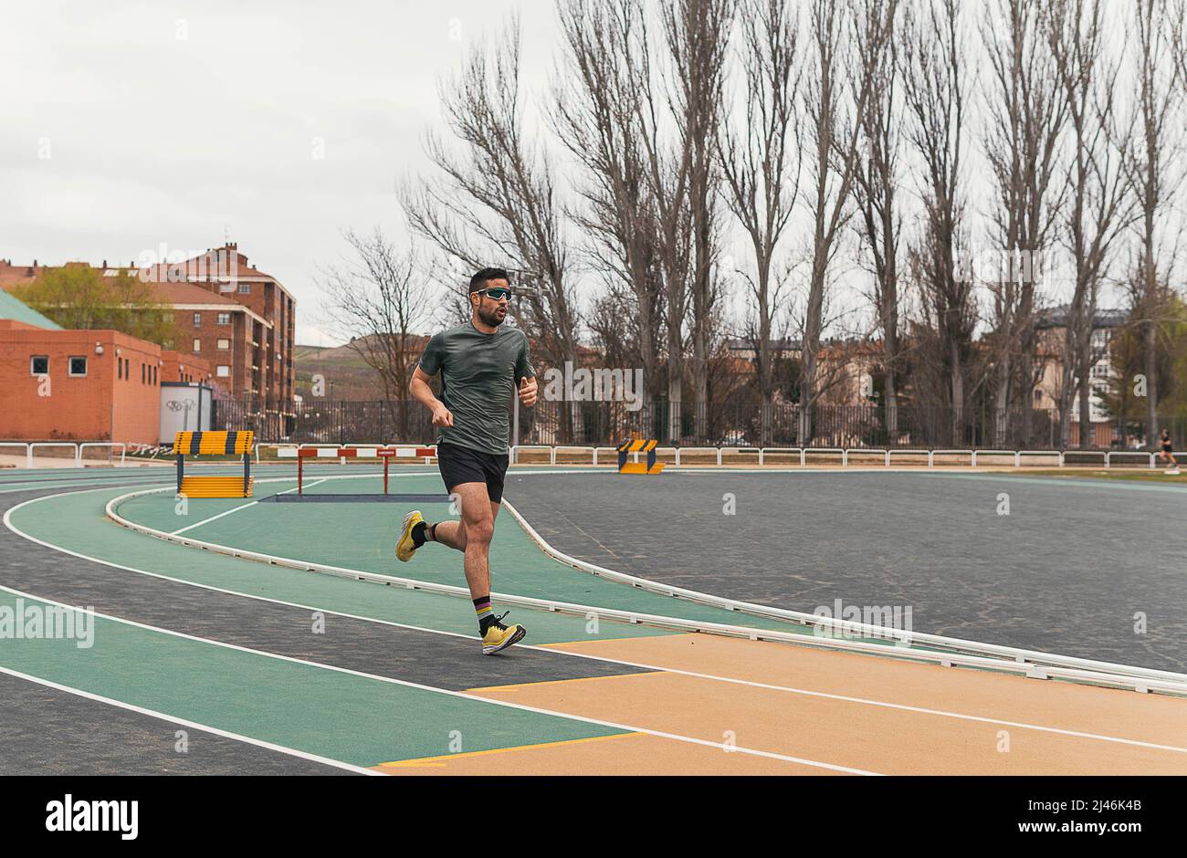 man running on a running track Stock Photo - Alamy
