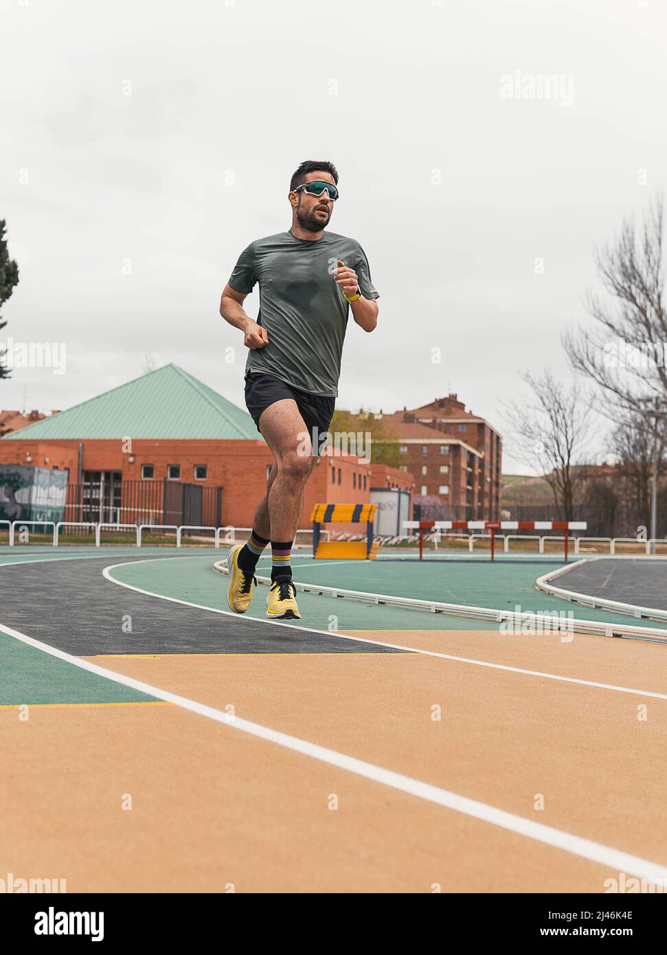 man running on a running track Stock Photo - Alamy