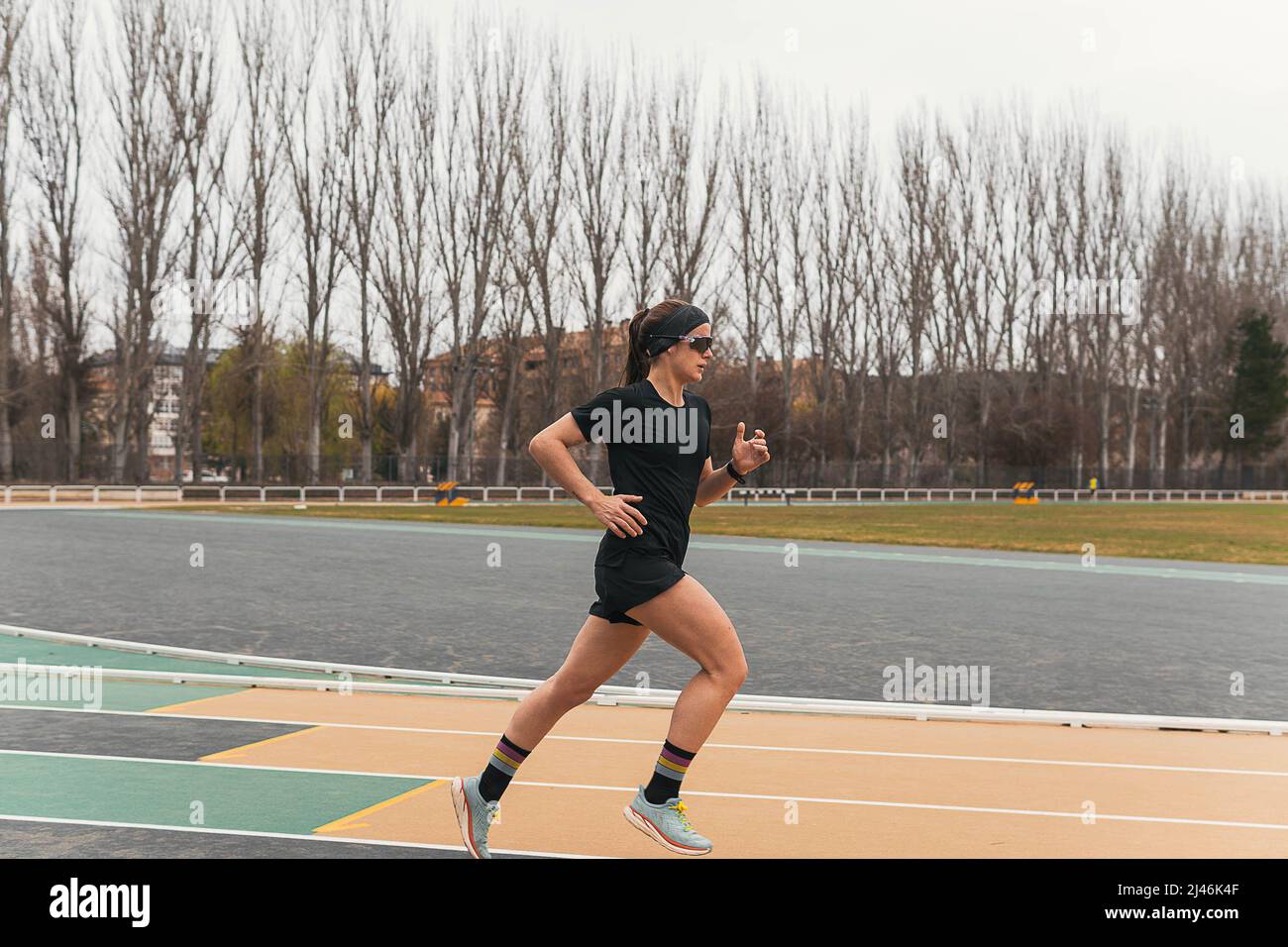 woman running on a running track Stock Photo - Alamy