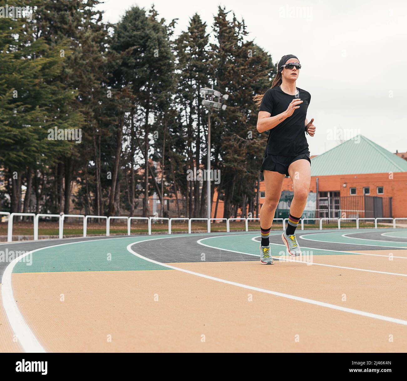 woman running on a running track Stock Photo - Alamy