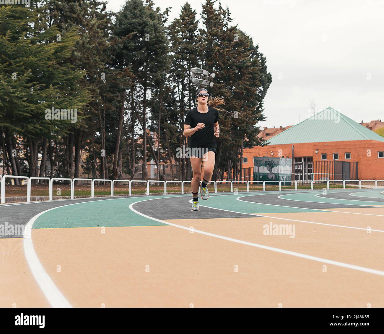woman running on a running track Stock Photo - Alamy