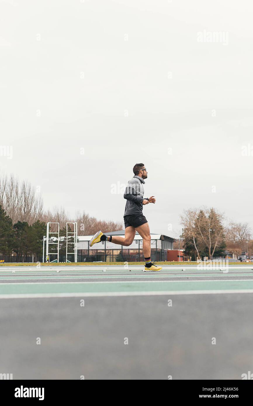 man running on a running track Stock Photo - Alamy