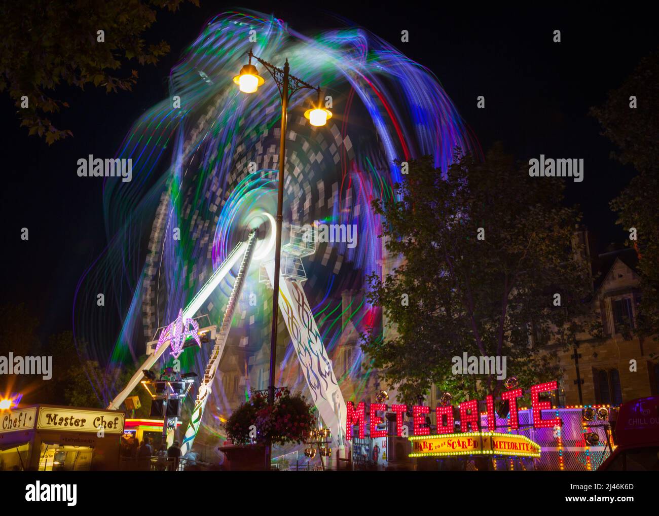 Long exposure image of the The 'Air' and 'Metorite' fairground rides at ...
