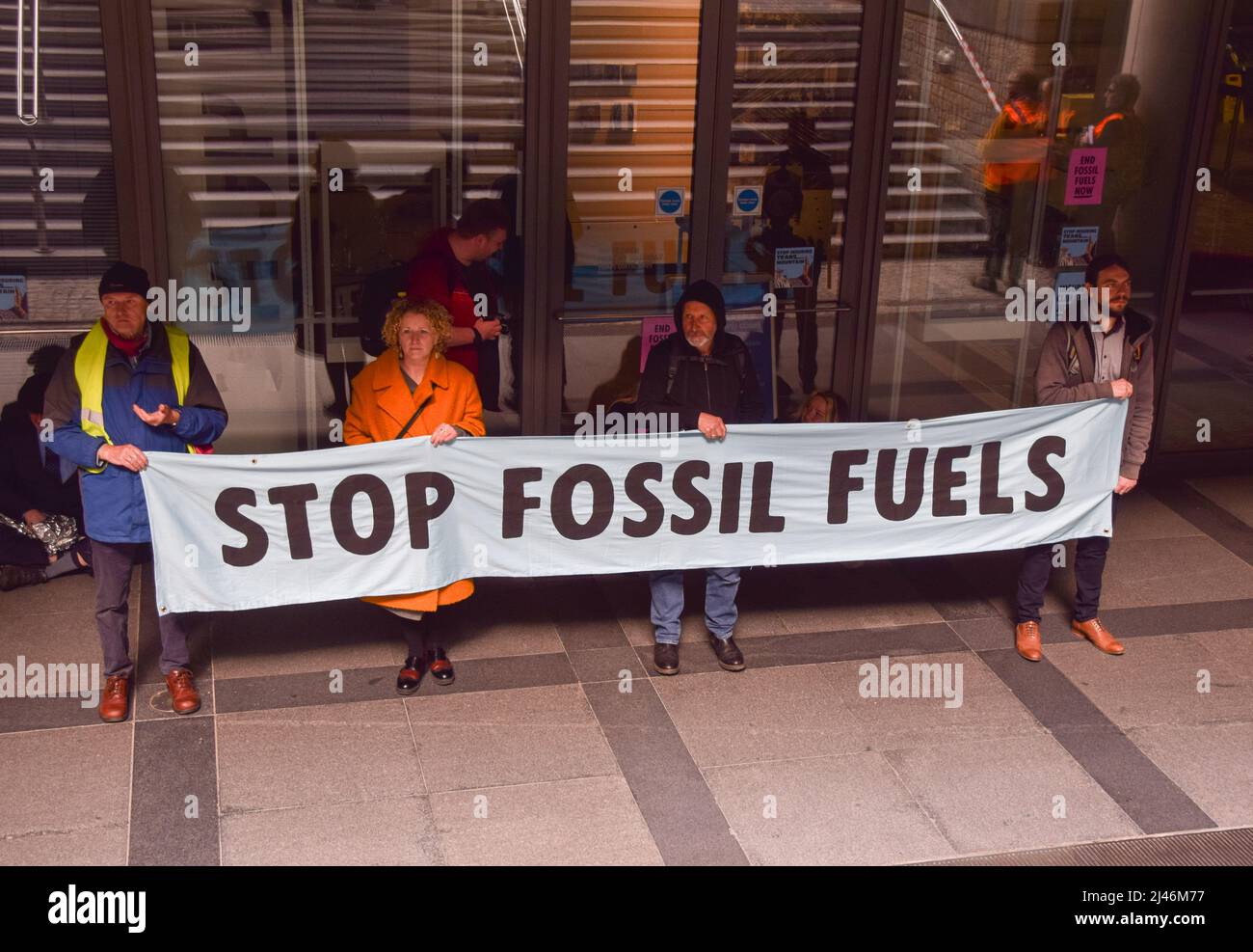 London, UK. 12th April 2022. Protesters hold a 'Stop fossil fuels ...