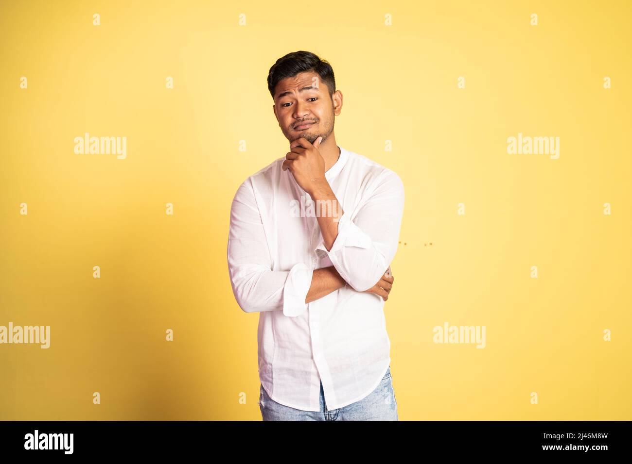 asian young man with sarcastic expression with hand holding chin Stock ...