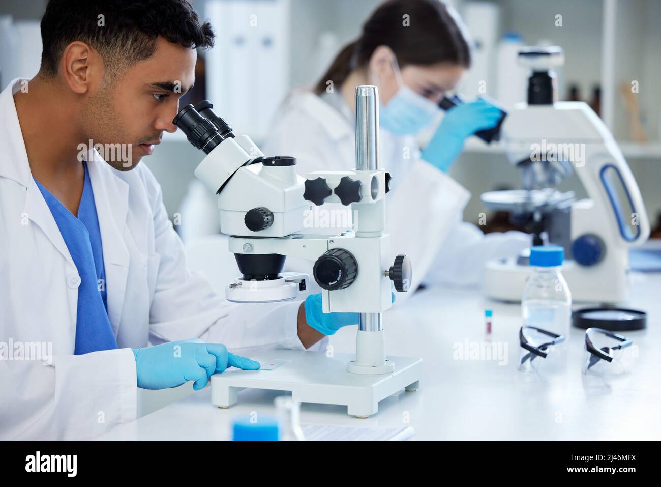 Scientists working using microscope hi-res stock photography and images - Alamy