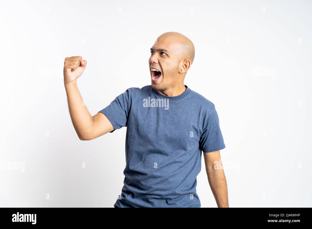 excited bald man screaming with one hand clenched Stock Photo - Alamy