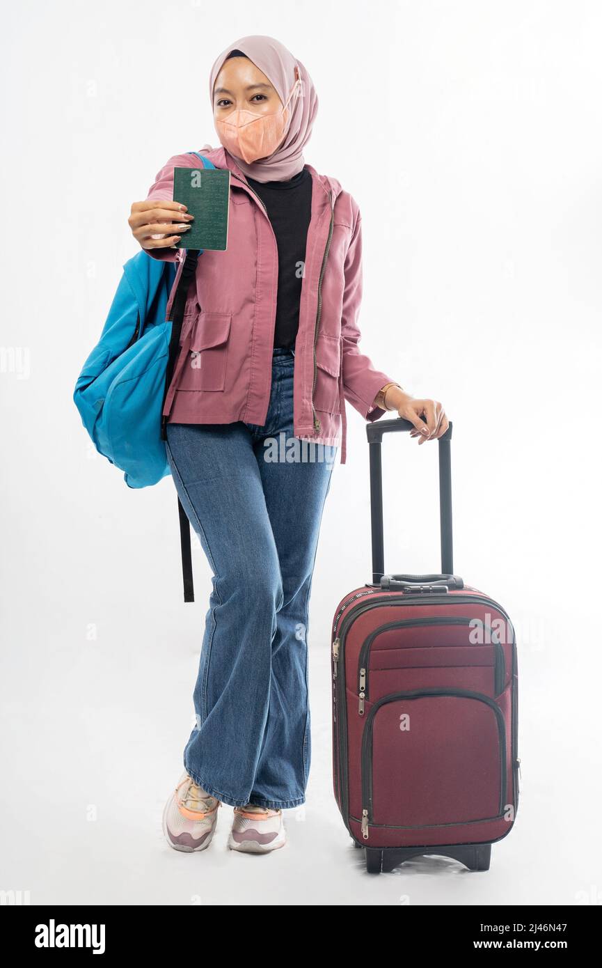 Hijab woman travelling holding passport, ticket, suitcase and carrying ...