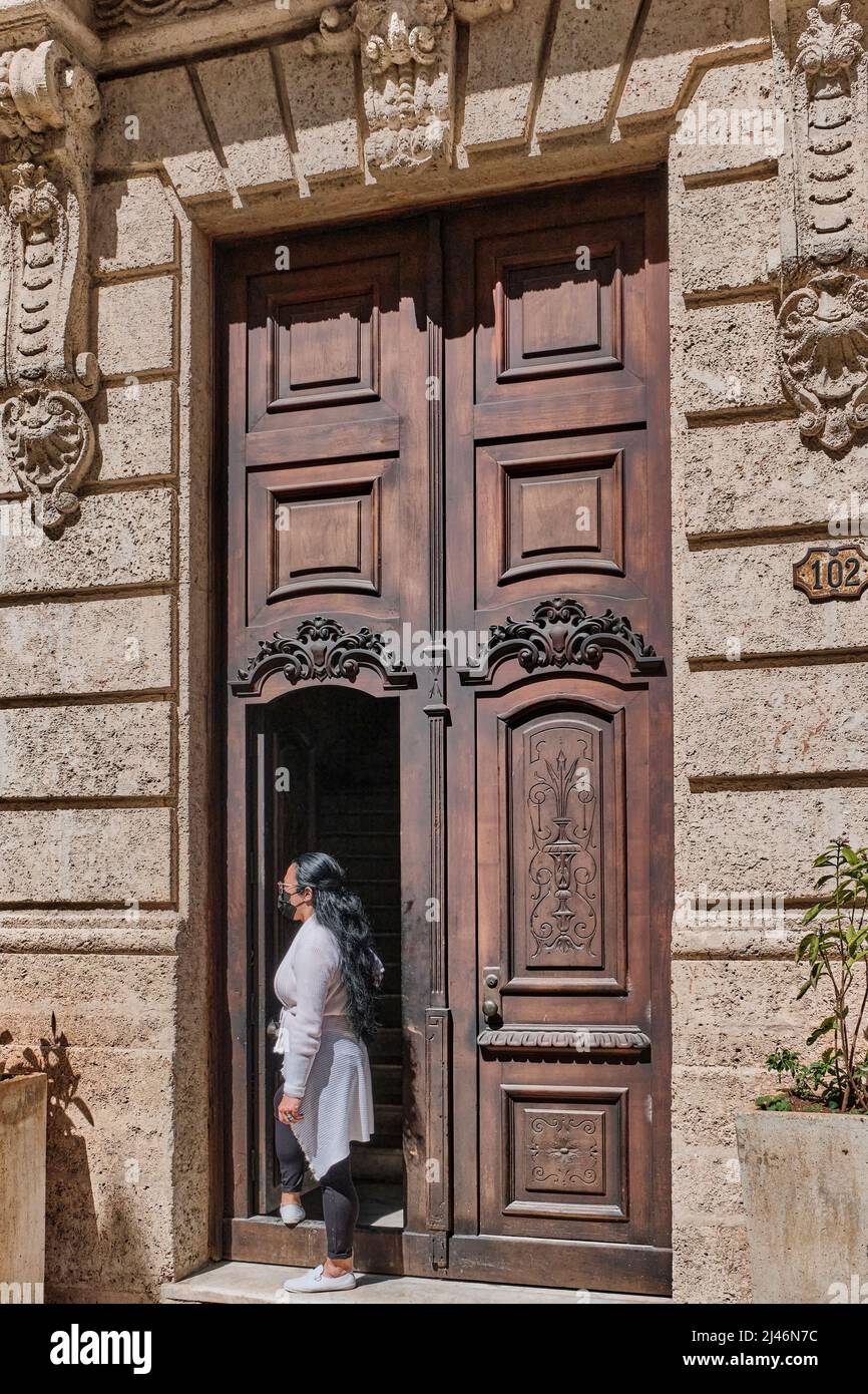 Front wooden high door in colonial building of old Havana, with ...