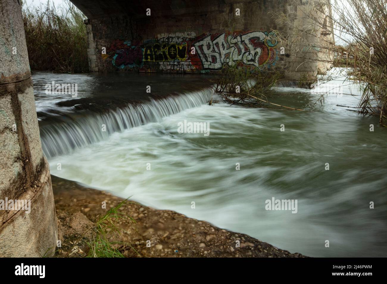 Natural landscape of Algar river in flood rushing under the road bridge ...