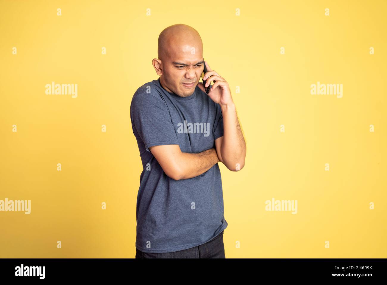 Serious asian bald man listening while calling Stock Photo - Alamy Serious asian bald man listening while calling Stock Photo - Alamy