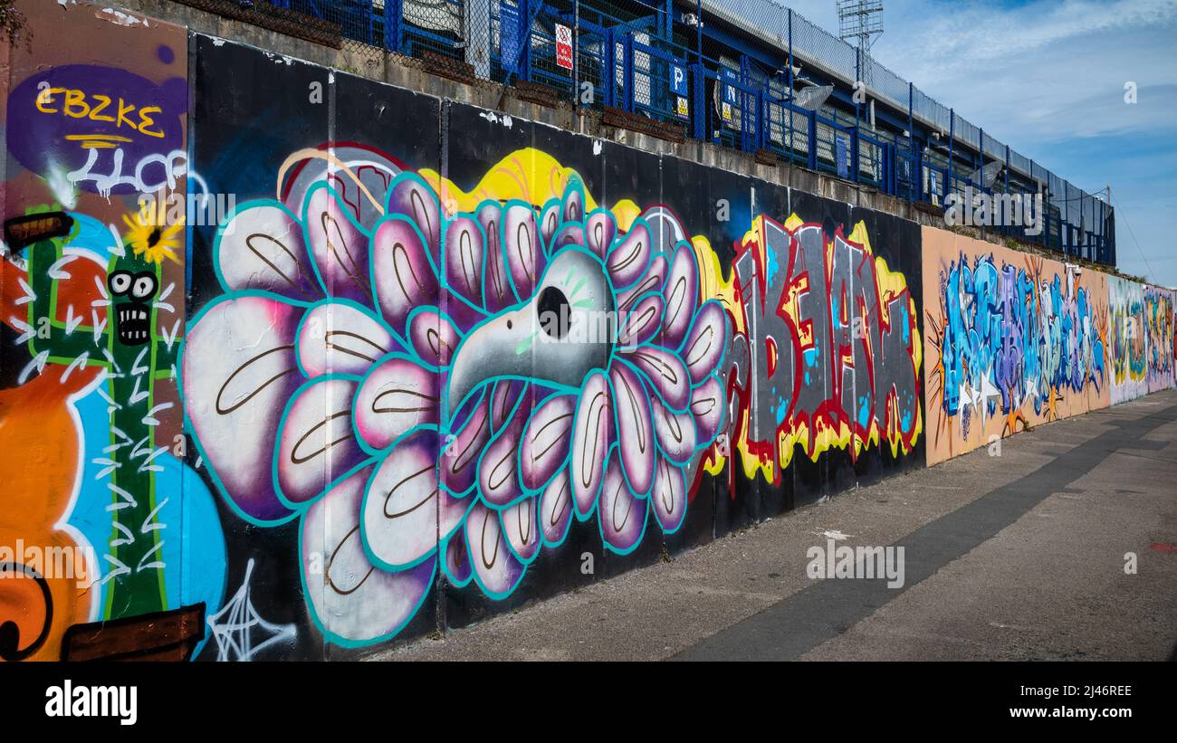 Colourful graffiti painted on a wall behind Fratton Park, the old ...