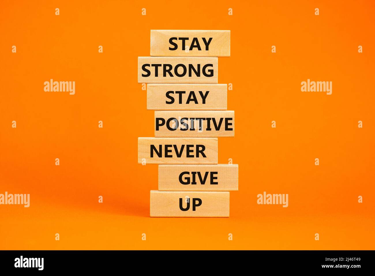 Never give up symbol. Wooden blocks with concept words Stay strong stay ...