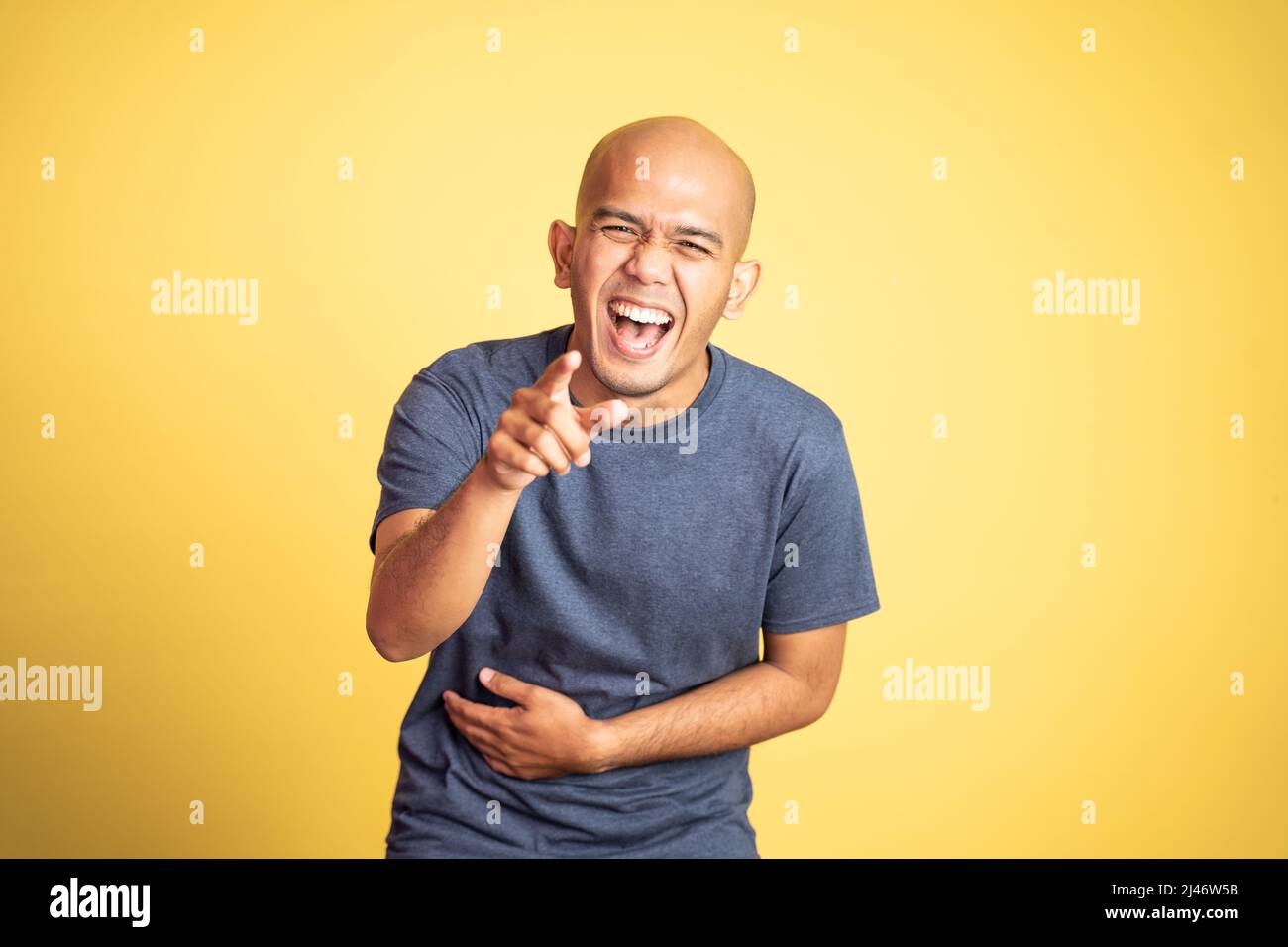 laughing asian bald man with finger pointing on camera Stock Photo - Alamy