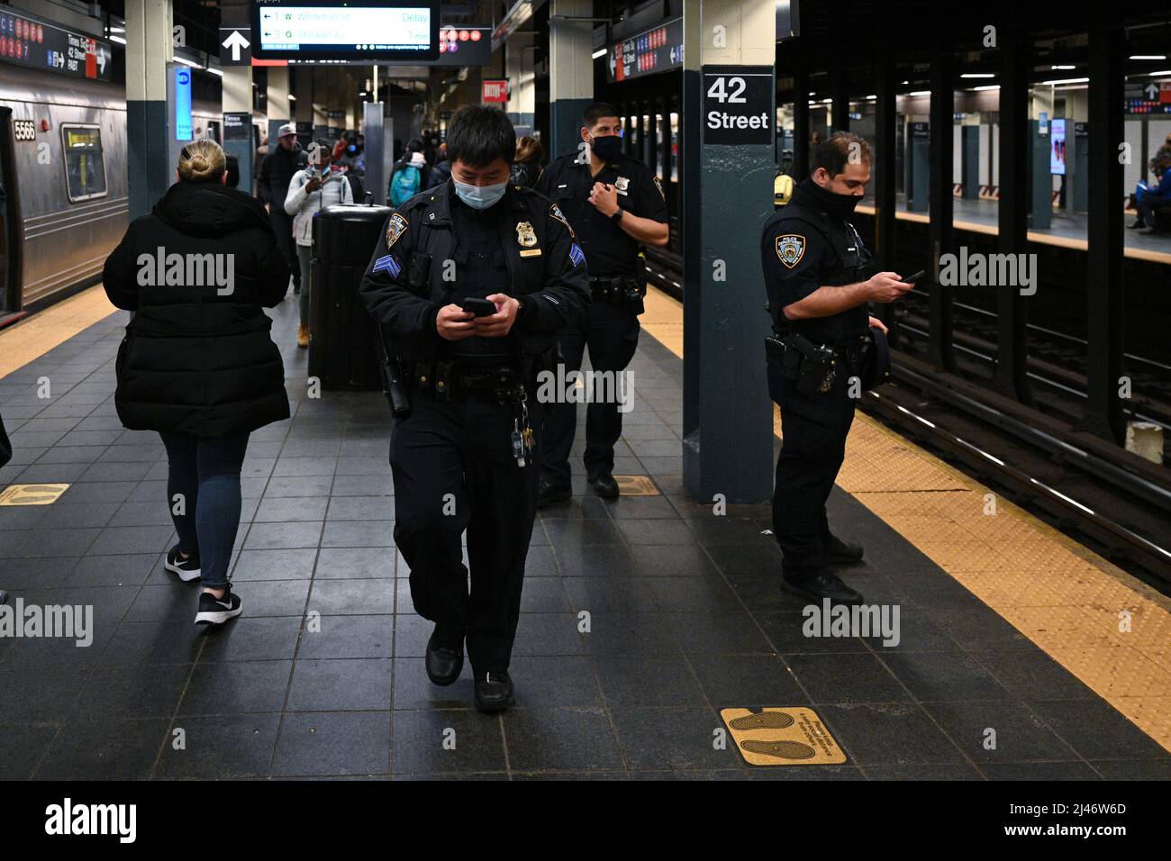 Police officers patrol the subway platform at 42nd Street-Times Square ...