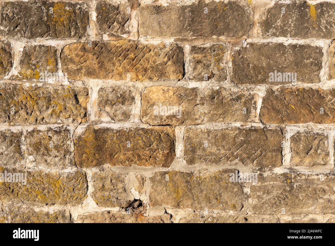Stone block wall background. Weathered building exterior surface as an ...