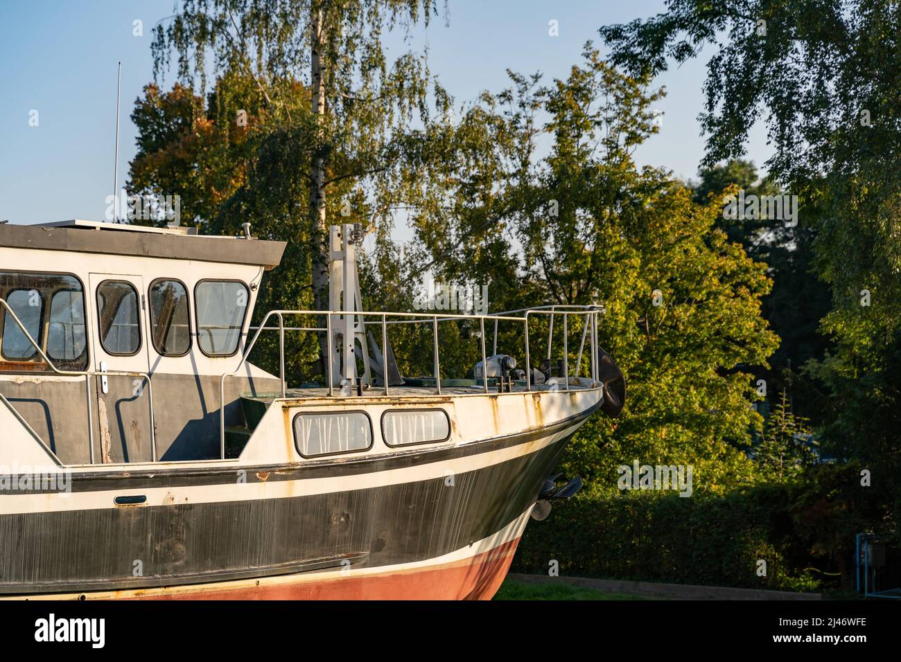 Old weathered boat in sunset sunlight. Rusty rough exterior with dirt ...