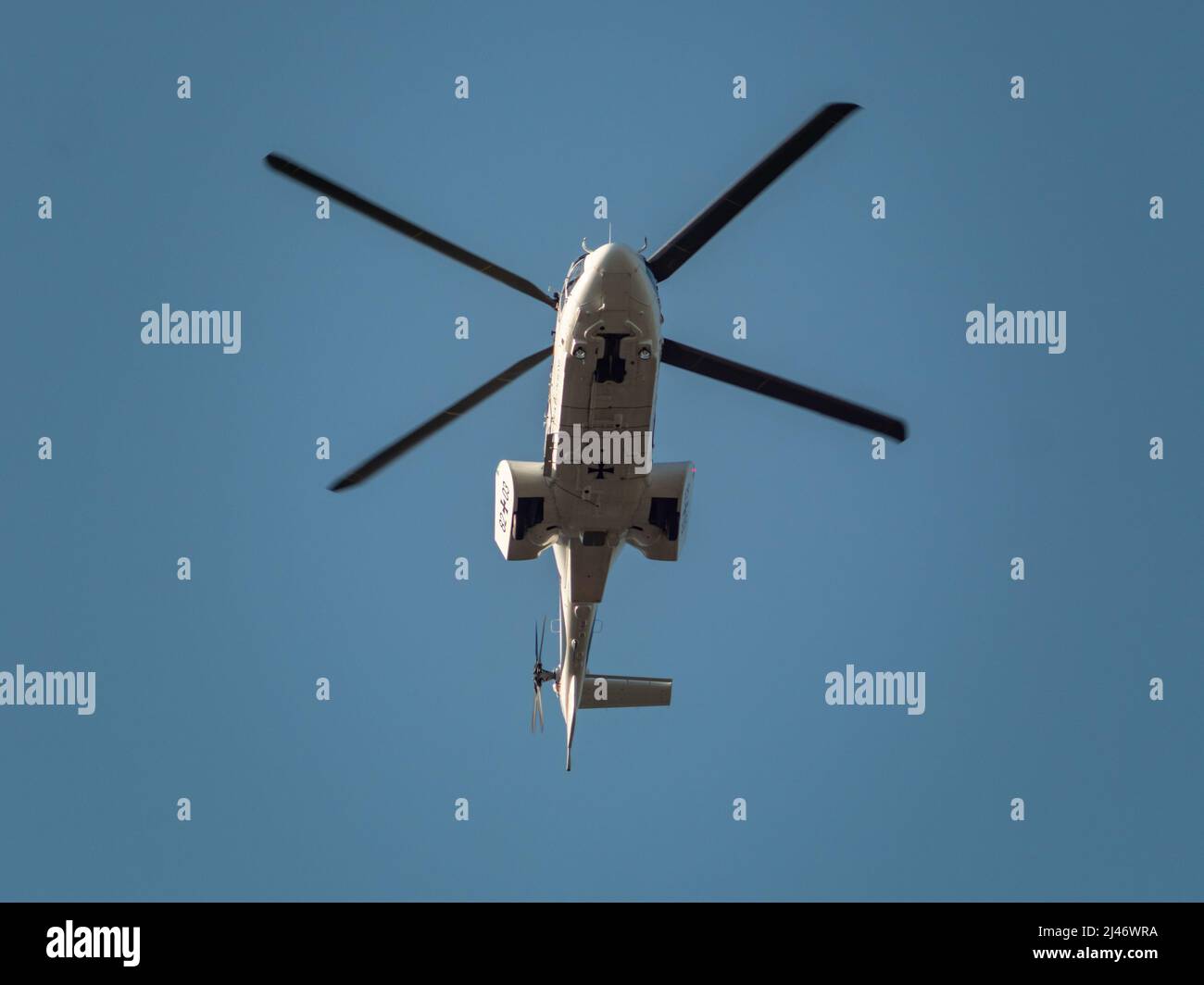 Bundeswehr helicopter flying over. Grey chopper of the german army on ...