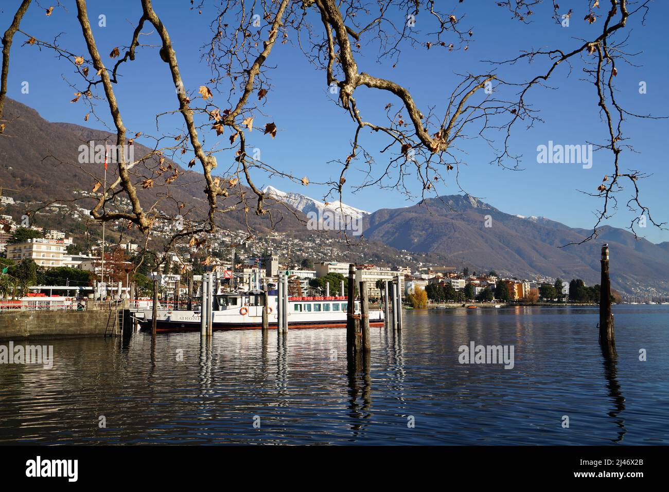 Winter landscape of lake Maggiore with boats in Locarno, Switzerland ...