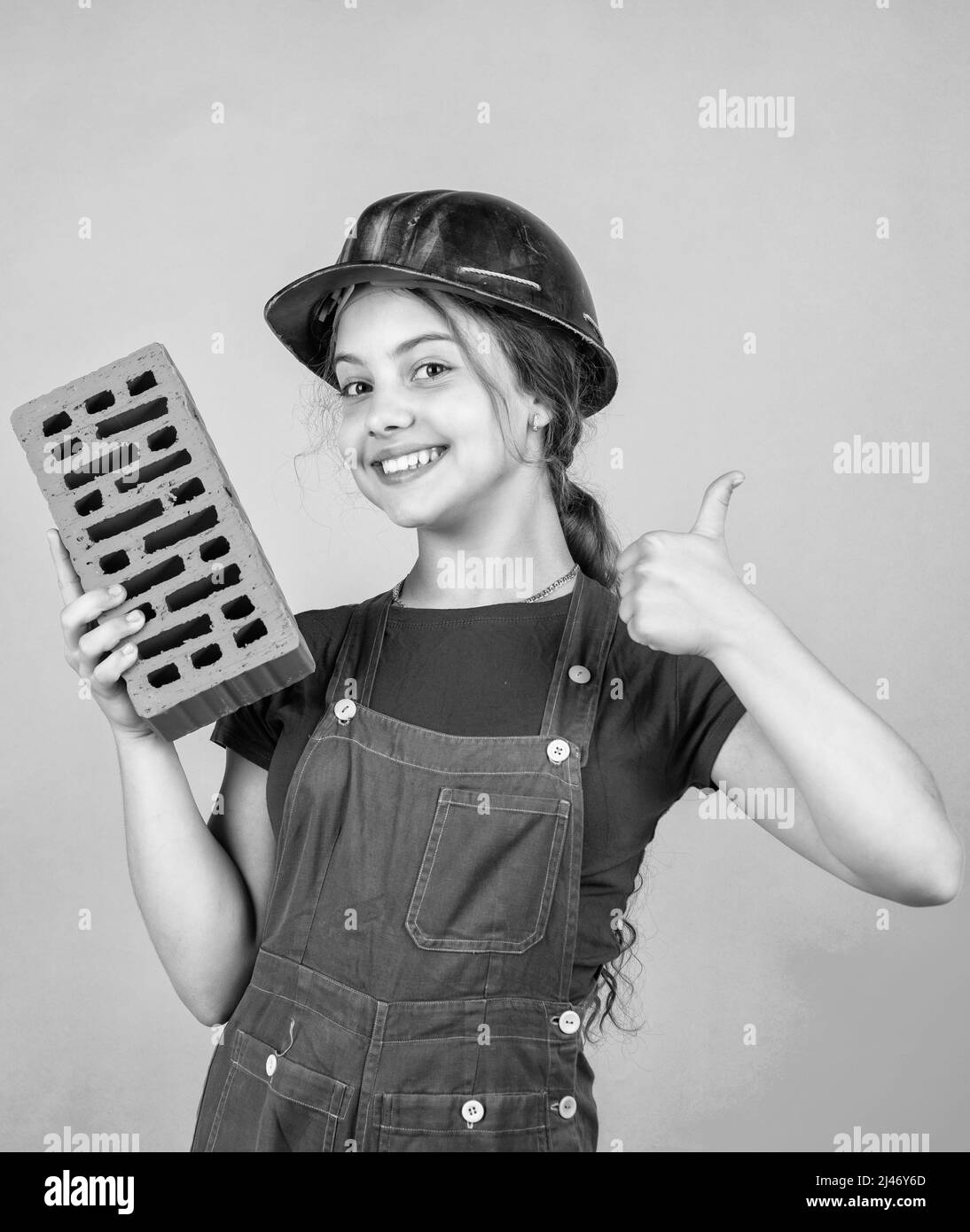 Build your future yourself. kid wear helmet on construction site. girl ...