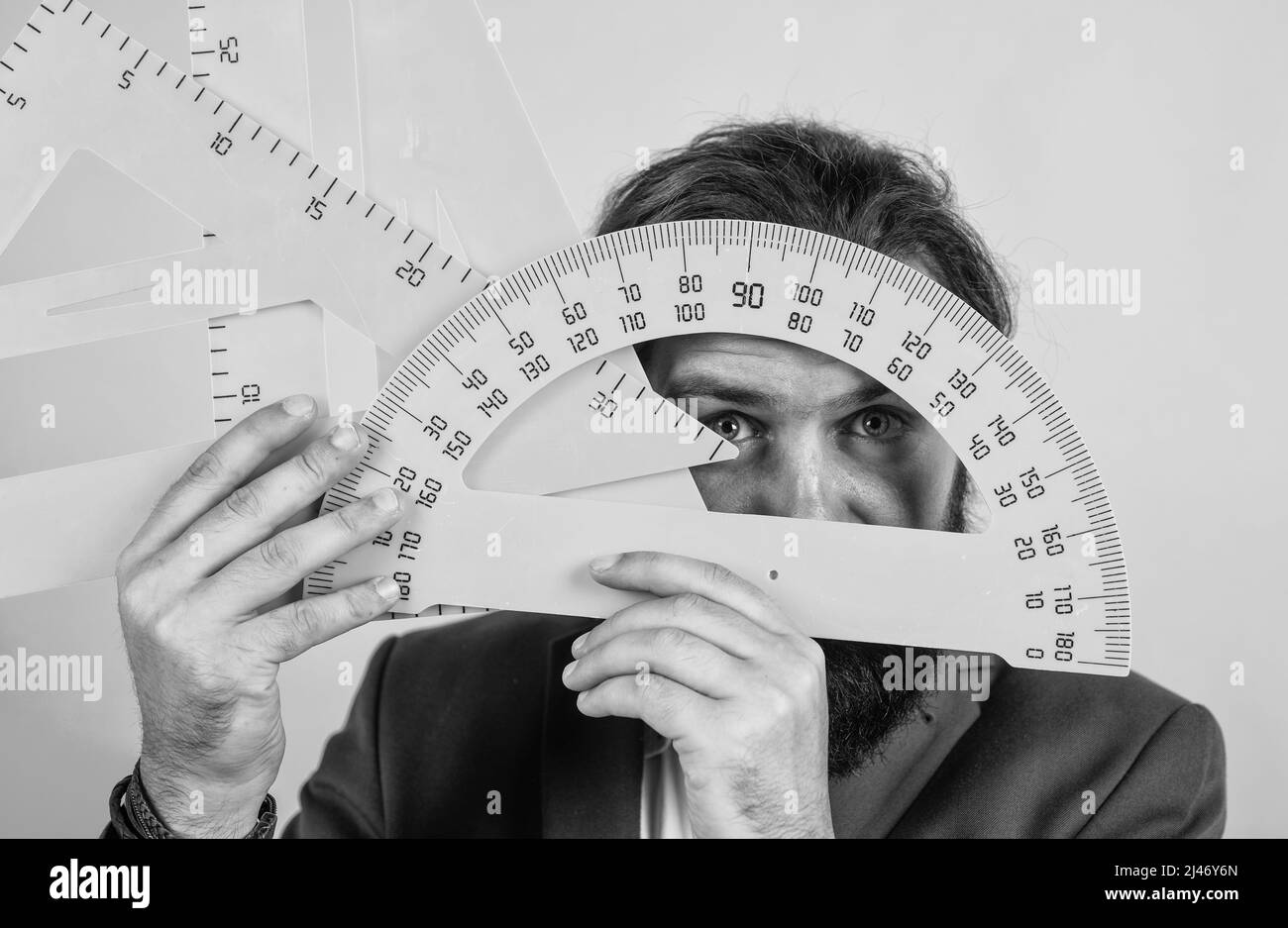 protractor and triangle tool in hand of math man teacher, education at ...