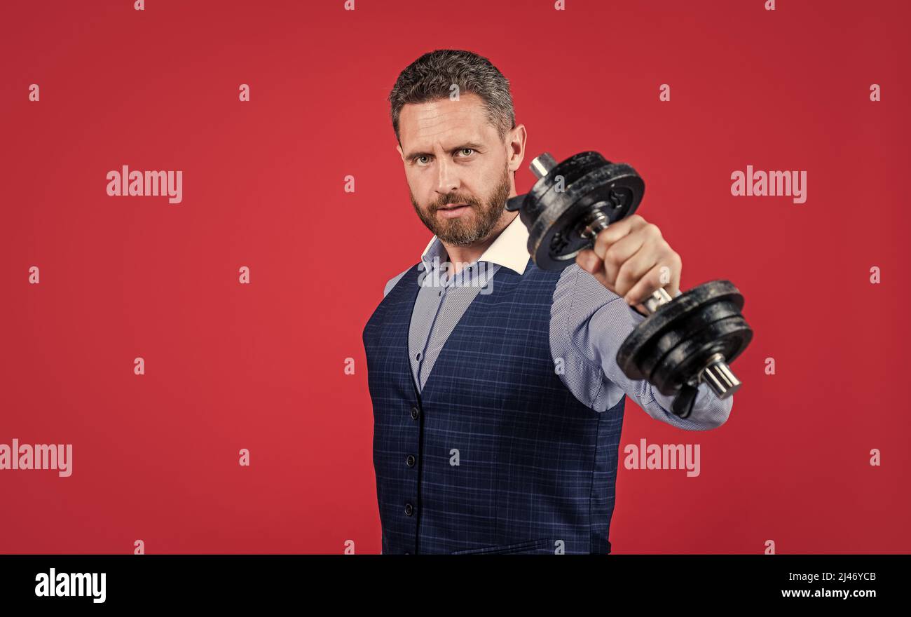 Strong man manager do dumbbell workout red background, business Stock ...