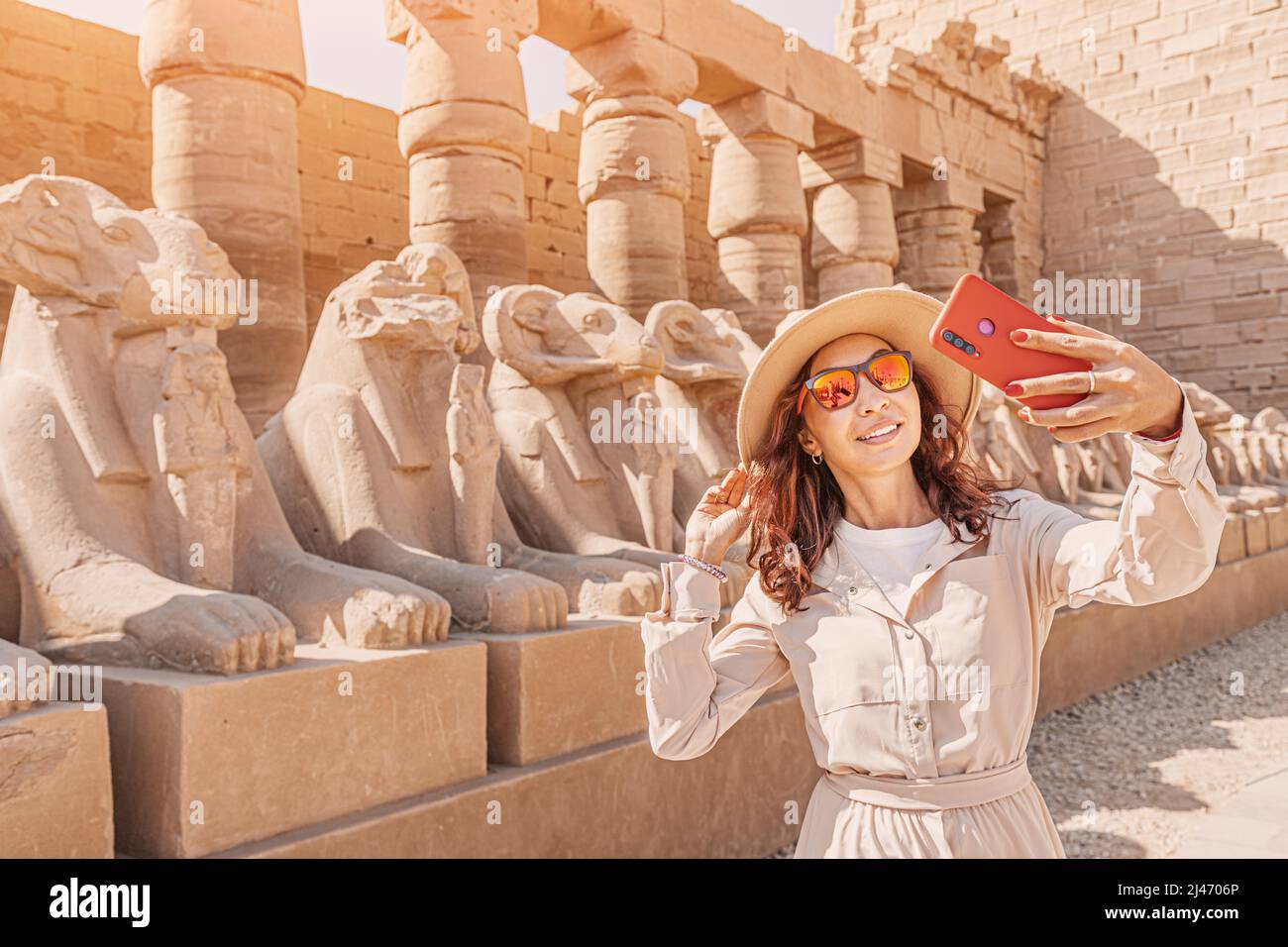 Travel blogger woman takes selfie photos among Pharaoh statues at the ...