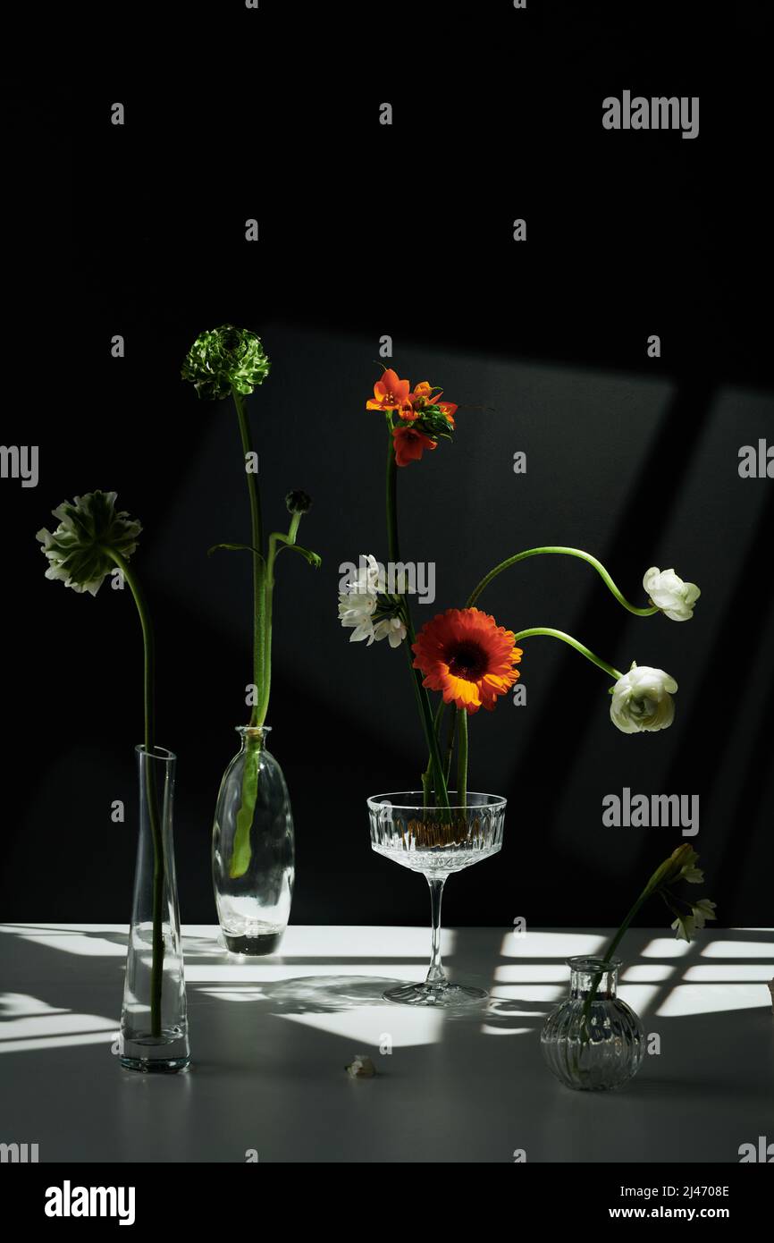 Vertical modern still life composition of various fresh flowers in ...