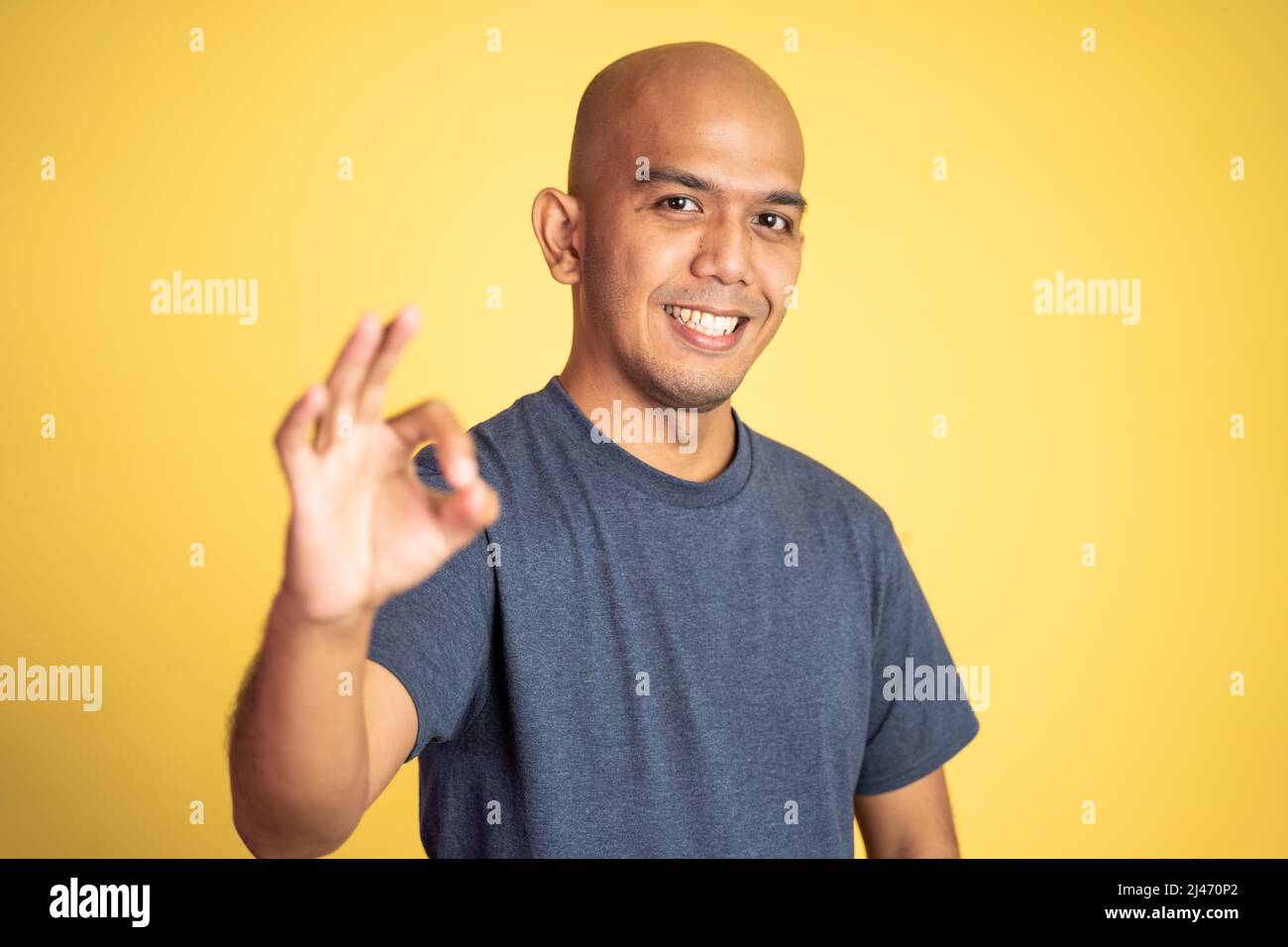 bald man showing okay hand gesture with smiling showing teeth Stock ...