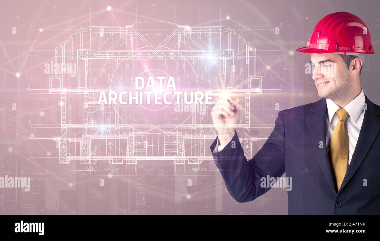 Handsome architect drawing with helmet Stock Photo - Alamy