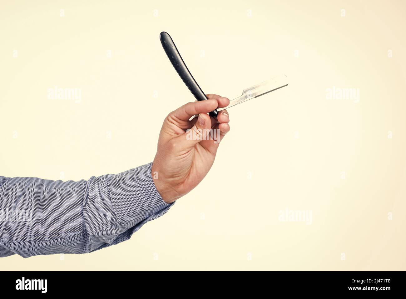 retro razor blade in hand of professional hairdresser isolated on white ...