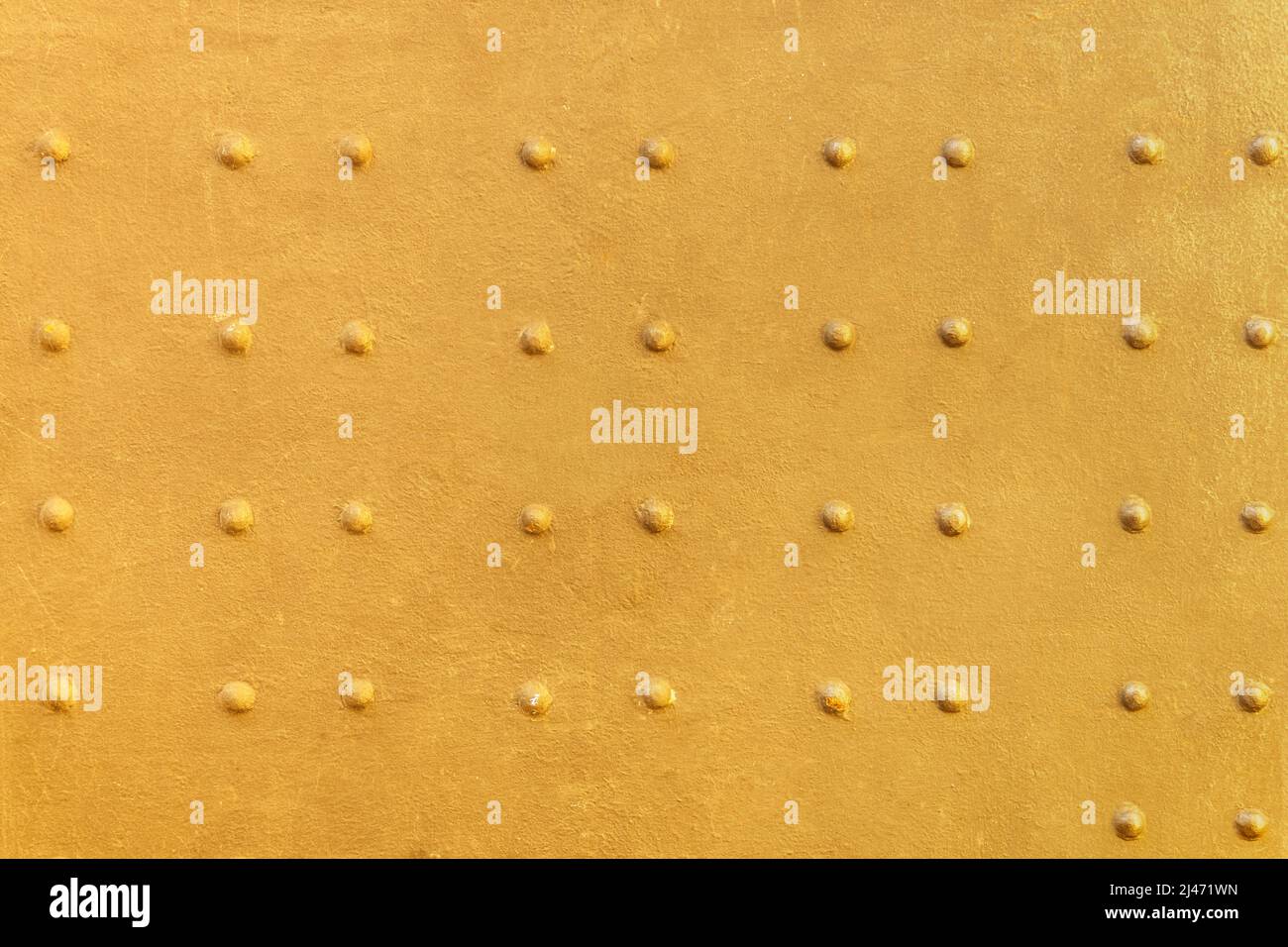 Metal texture with rows of rivets painted yellow. Bright and light ...