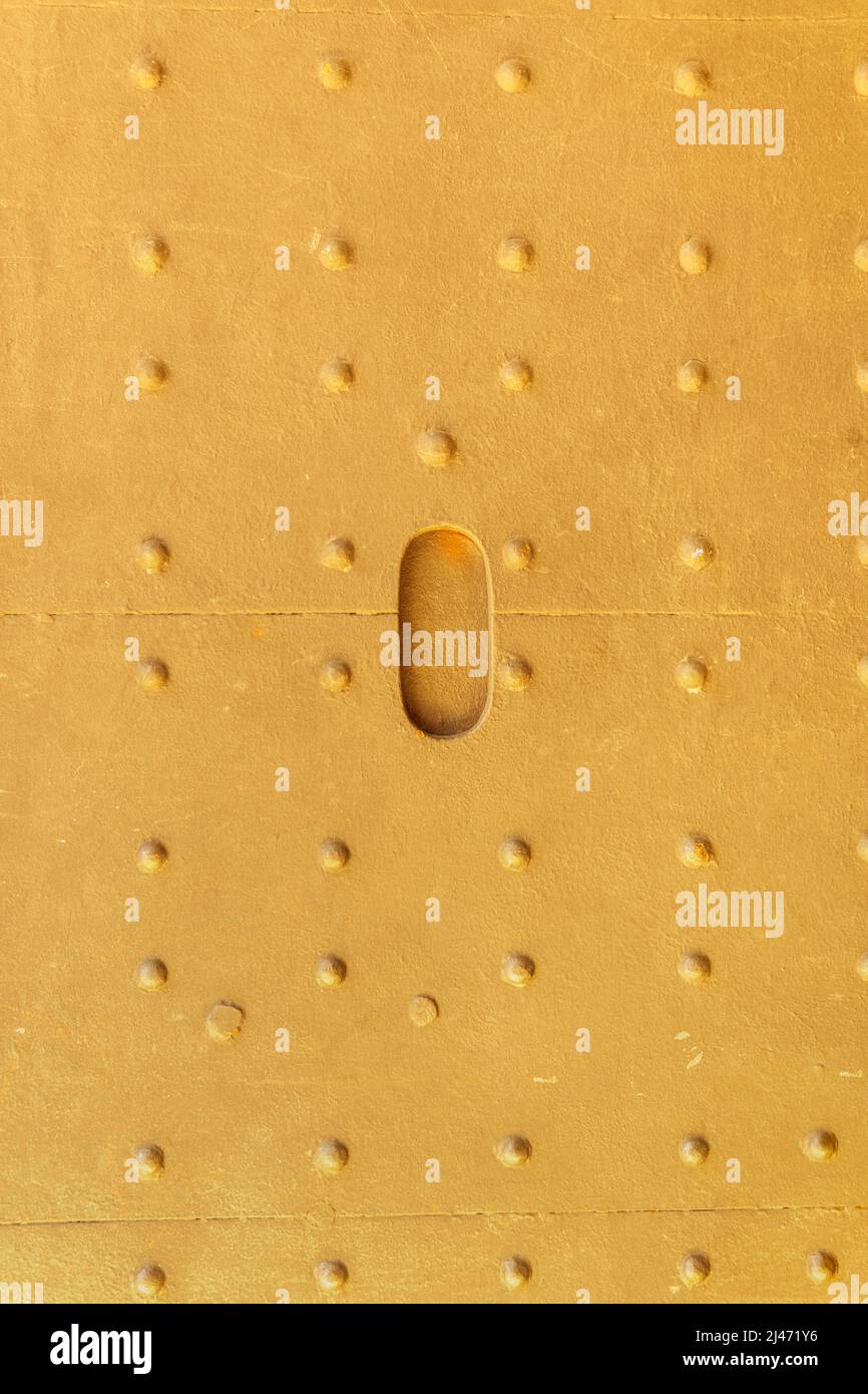 Metal texture with rows of rivets painted yellow. Bright and light ...