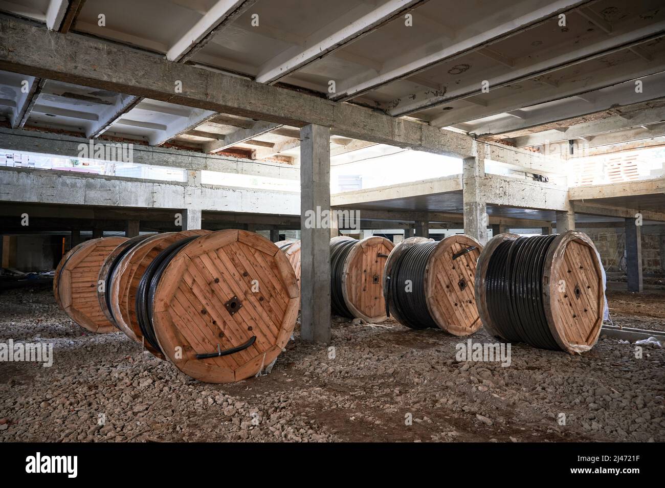 Large rolls of electric high-voltage power cable on floor on ...