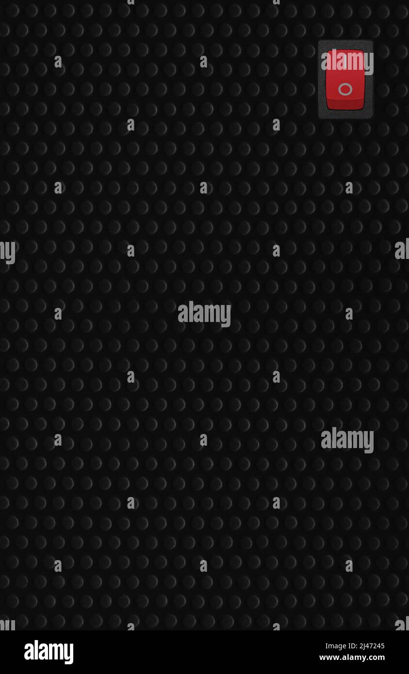 Red rectangle rocker power switch in on position, black abstract dot ...