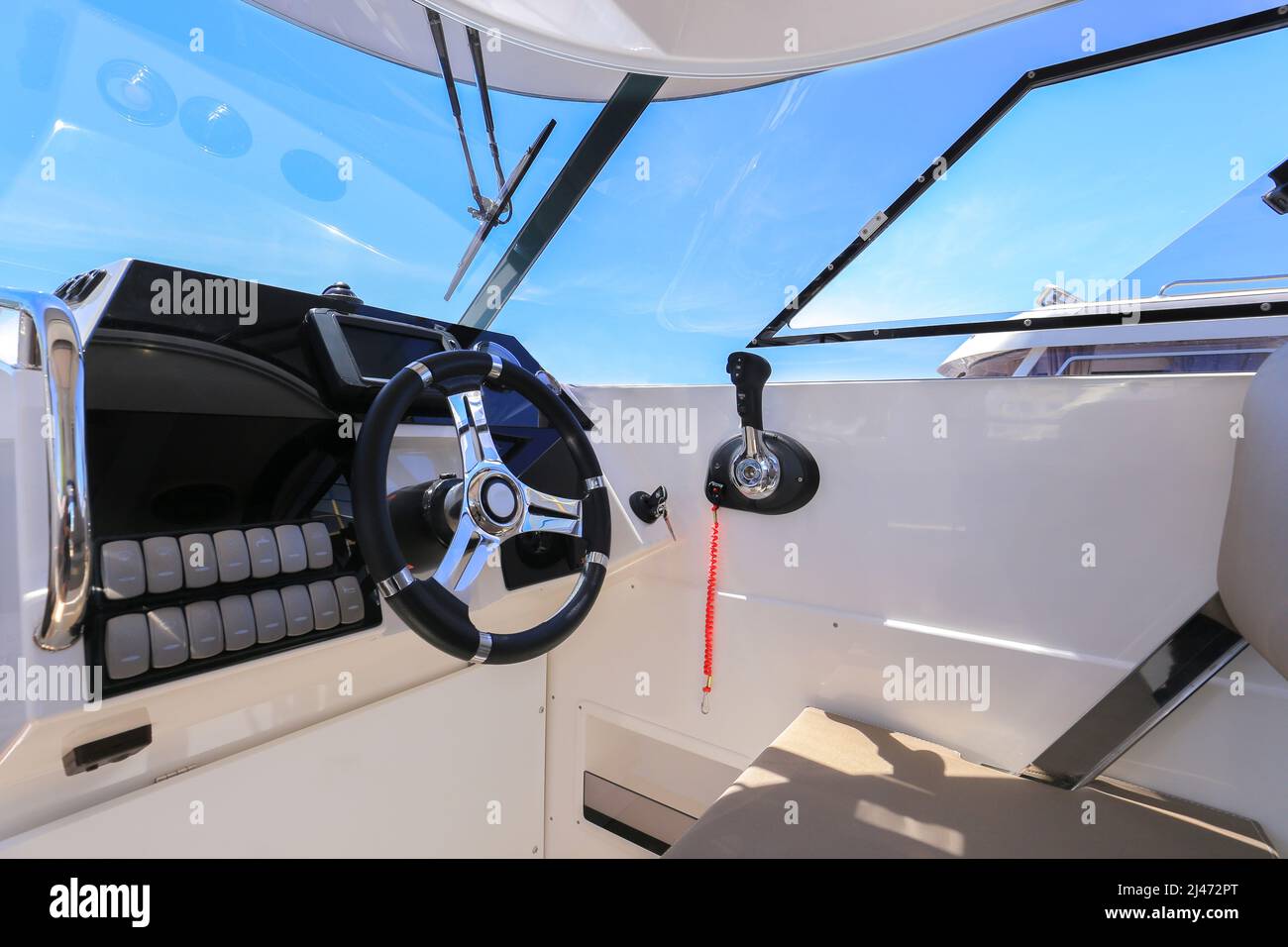 Cockpit modern motor boat with steering wheel and throttle control ...