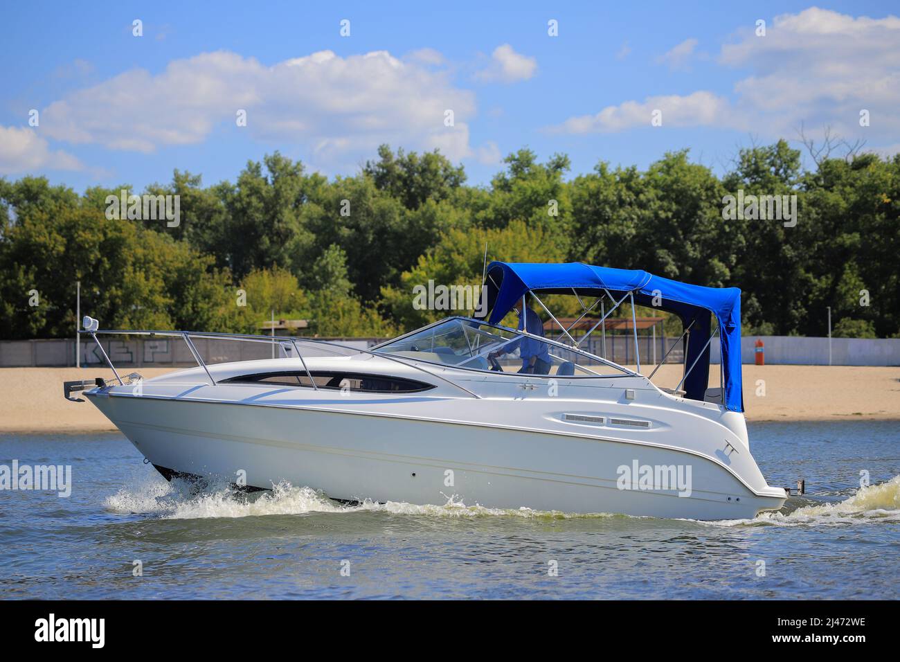 White motorboat floating on the river Stock Photo - Alamy