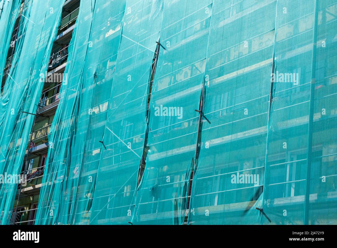 Building under construction wrapped green protection safety net Stock ...