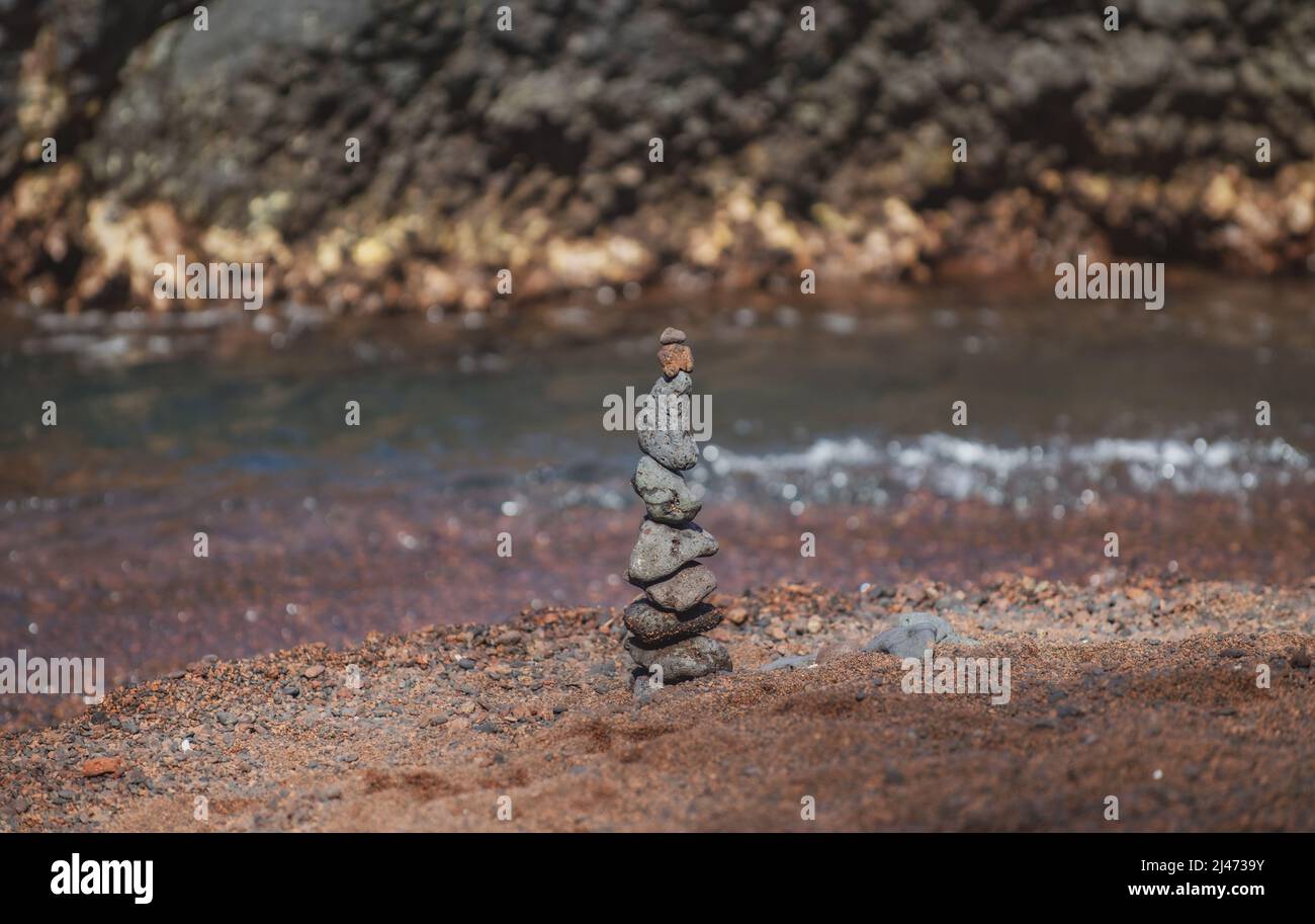 Balancing pyramid of sea pebbles on a beach background, the concept of ...