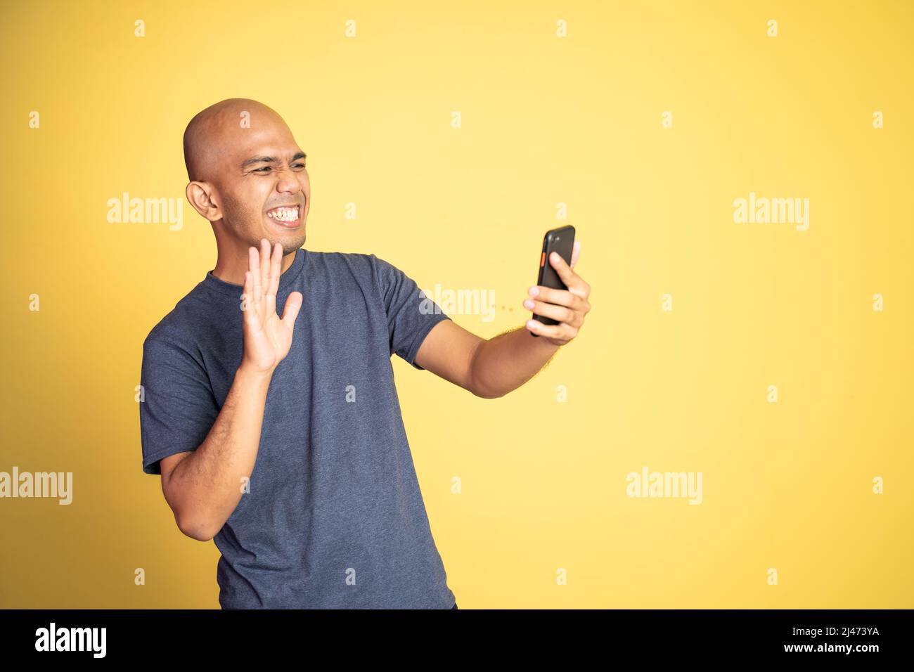 excited asian man waving hand when make video call Stock Photo - Alamy