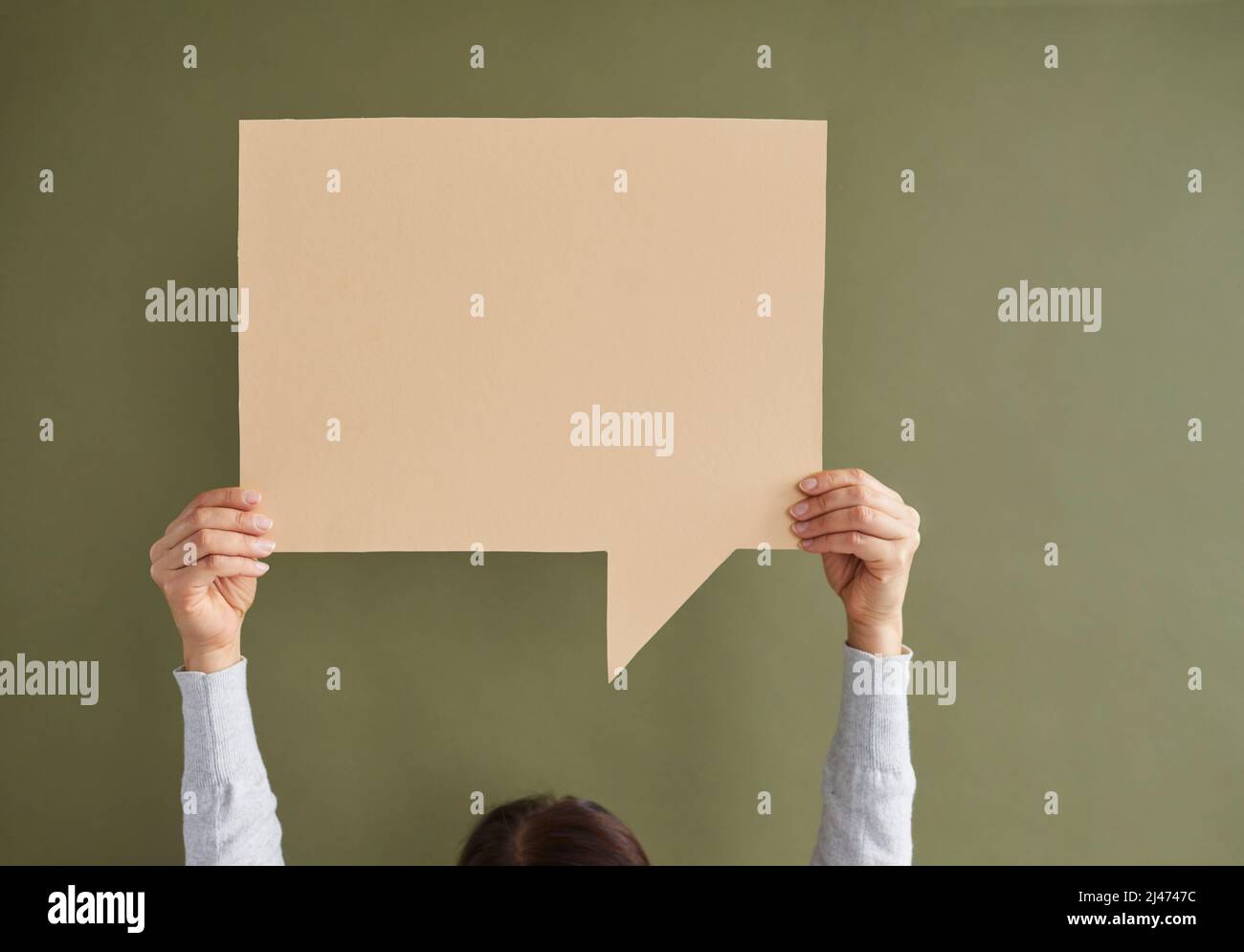 Woman holding rectangular speech balloon or message bubble with blank ...
