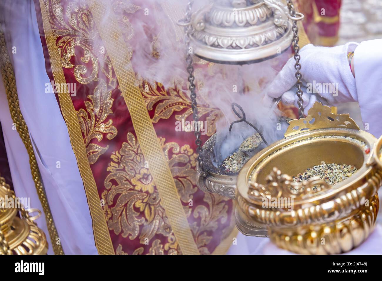 Filling one of the censers with incense in a Holy Week procession Stock ...