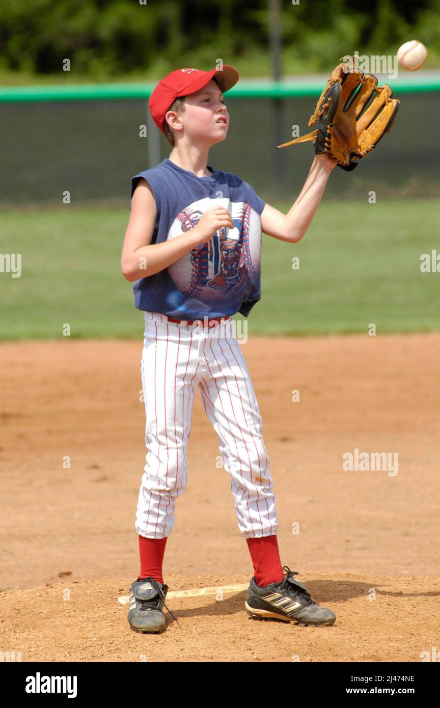 Young boys playing baseball on ball field, Pitcher, Catcher, Hitter and ...