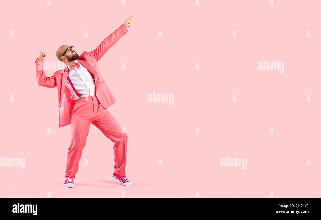 Cheerful successful man dancing funny making movements winner isolated ...