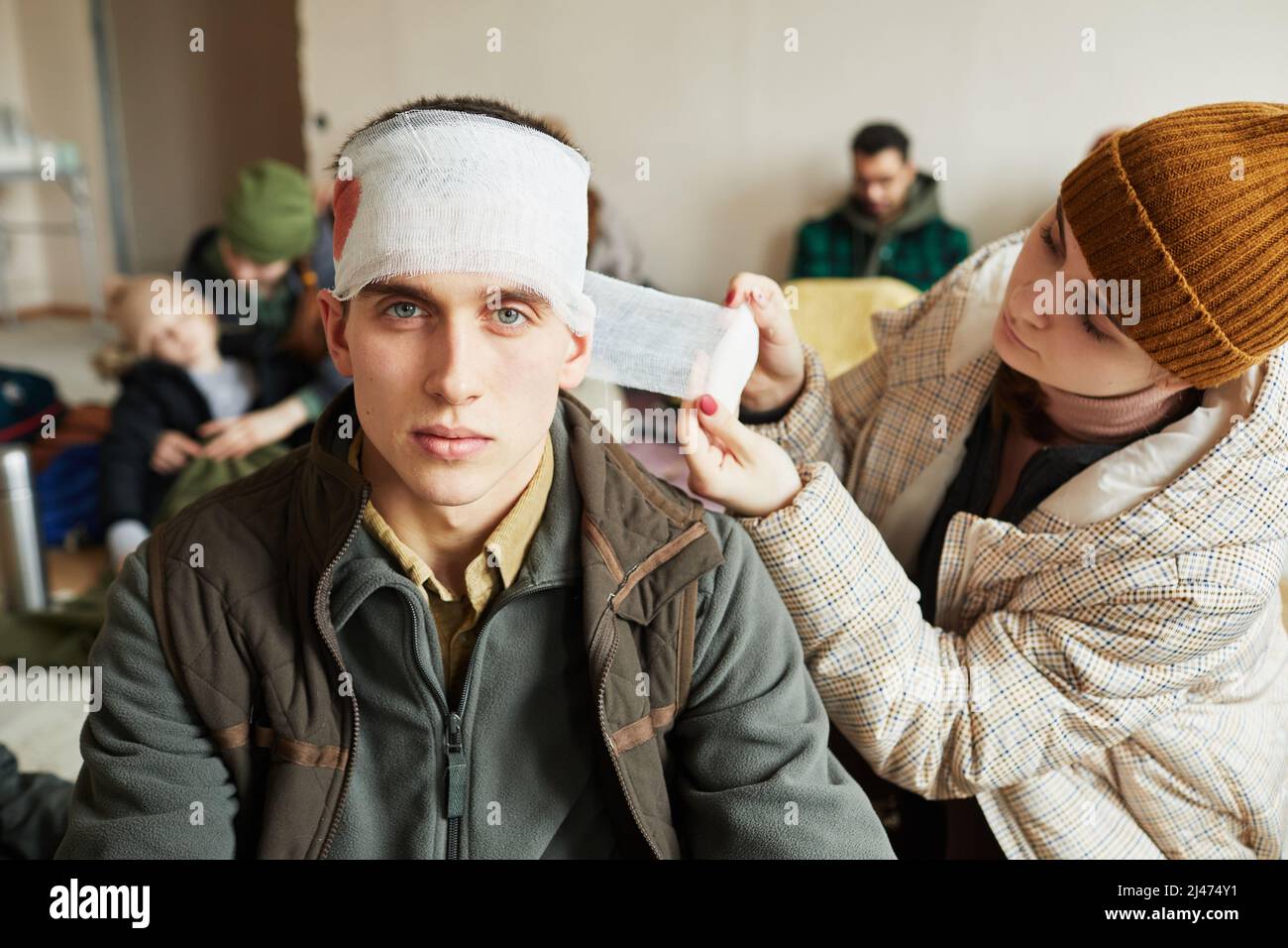 Front view portrait of Caucasian wounded man in refugee shelter with ...